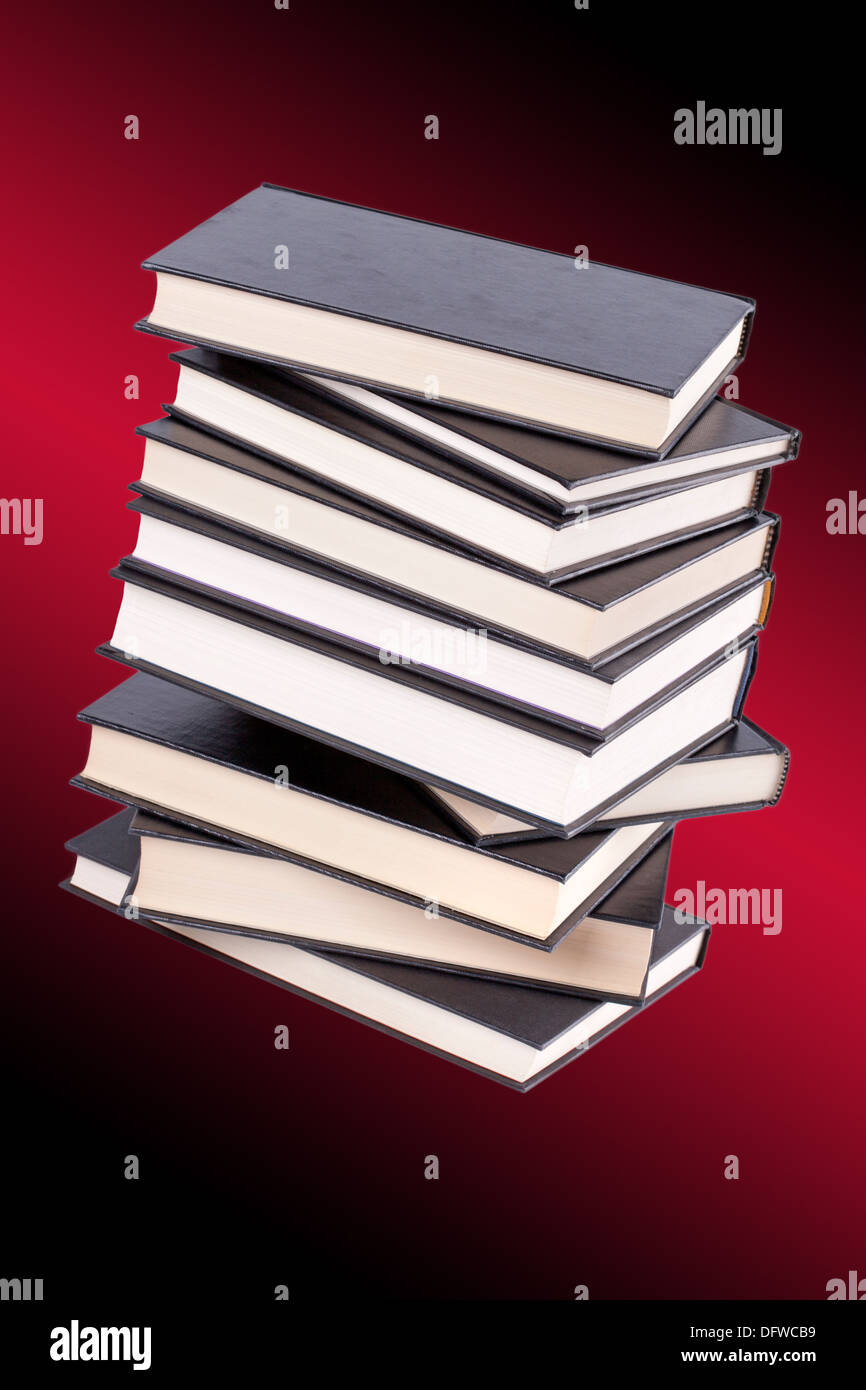 Stack of hardcover books on a colorful background Stock Photo - Alamy