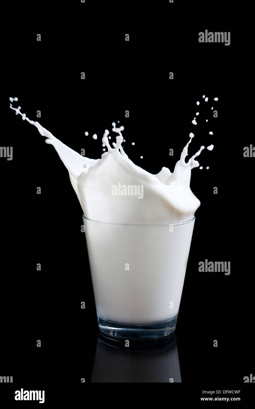 Splash of milk isolated on black Stock Photo - Alamy