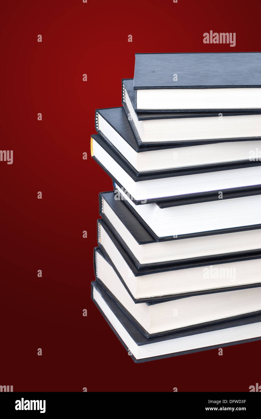 Stack of hardcover books on a colorful background Stock Photo - Alamy