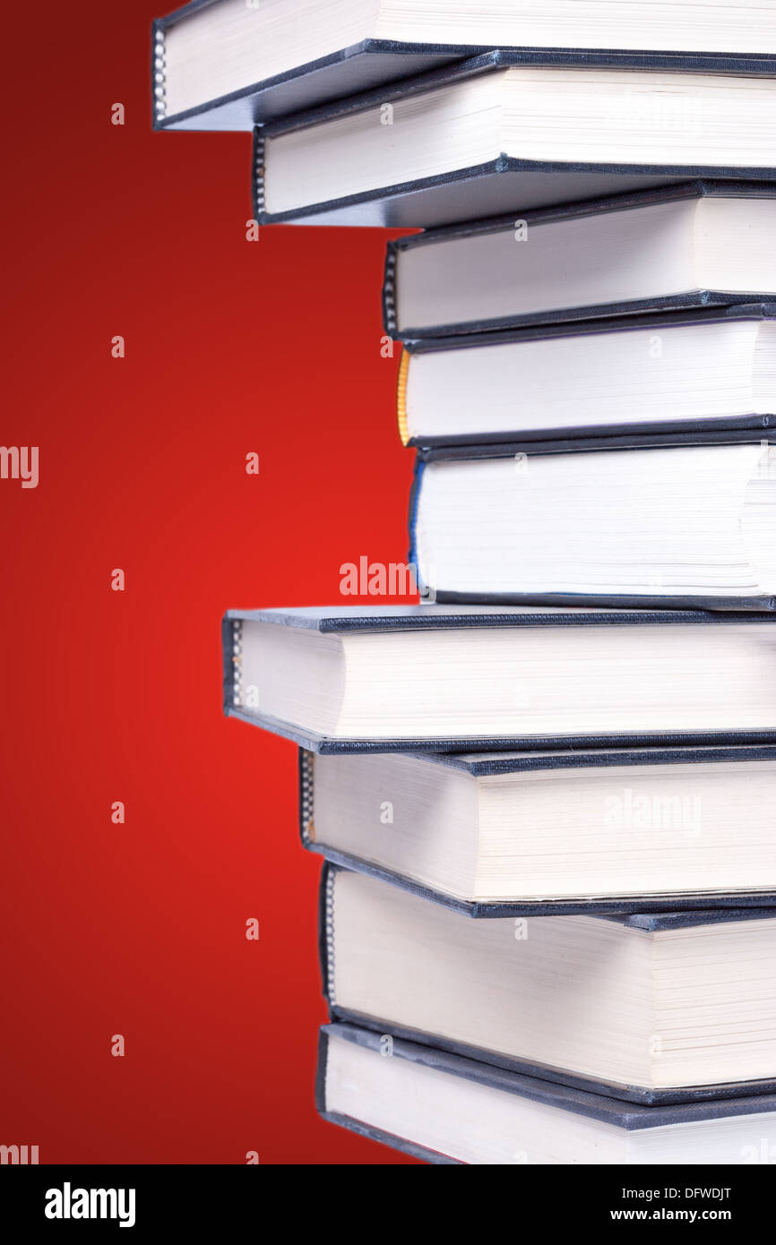 Stack of hardcover books on a colorful background Stock Photo - Alamy