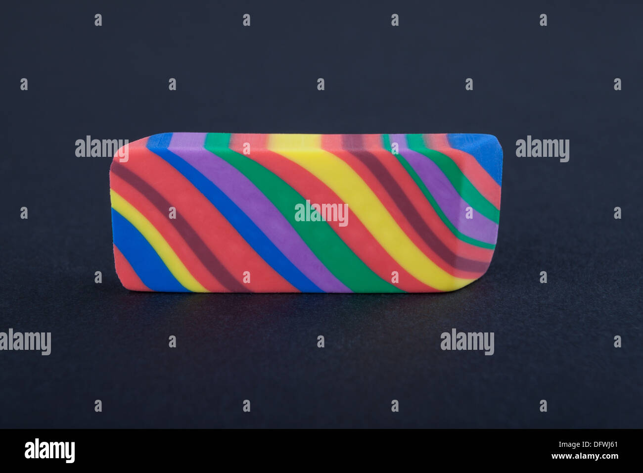 Rainbow colored eraser on the black background Stock Photo - Alamy