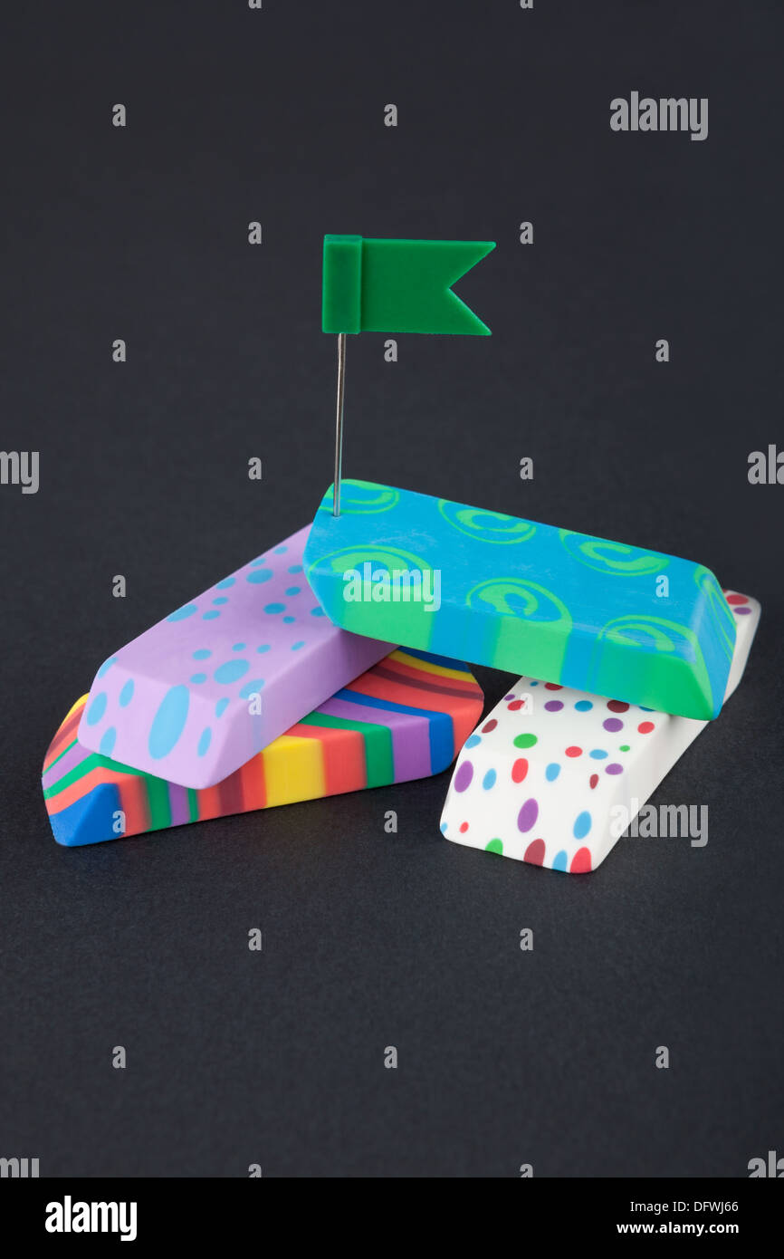 Colored eraser with green flag on the black background Stock Photo - Alamy