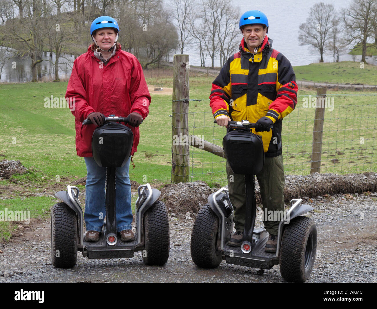 Two people posing on segway machines Stock Photo - Alamy