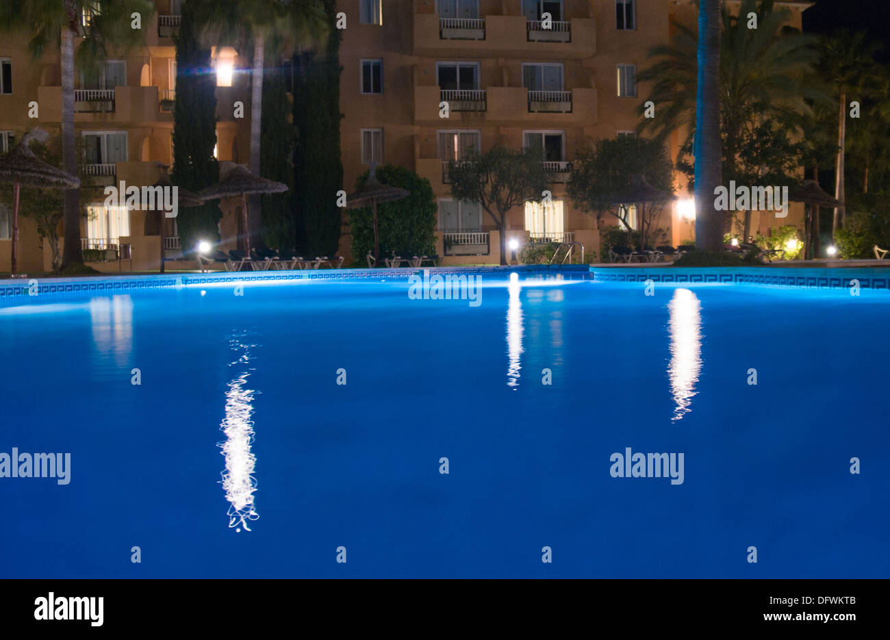 Hotel swimming pool at night Stock Photo - Alamy