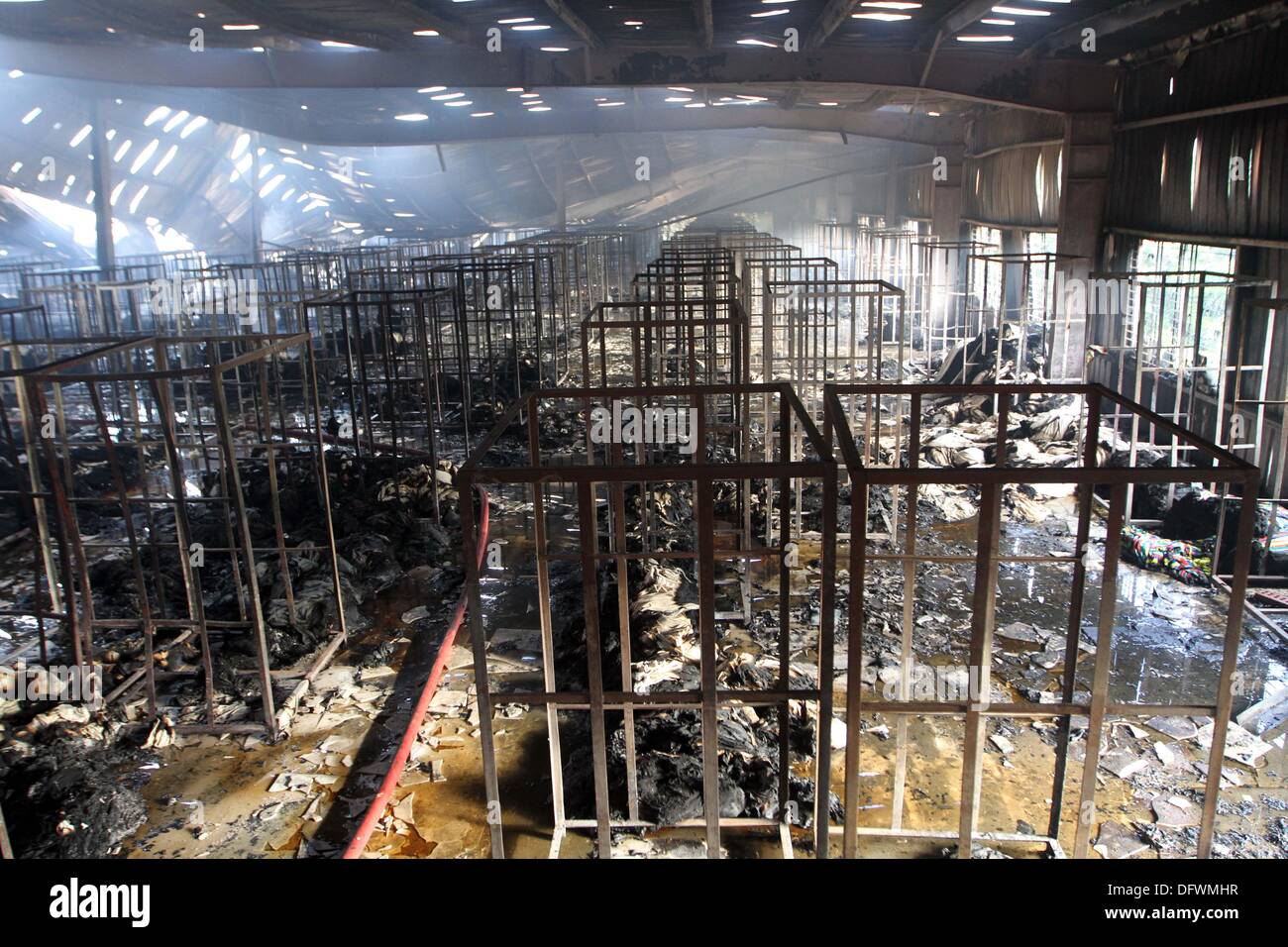 Burned machines are seen in a factory hall after a devastating fire at ...