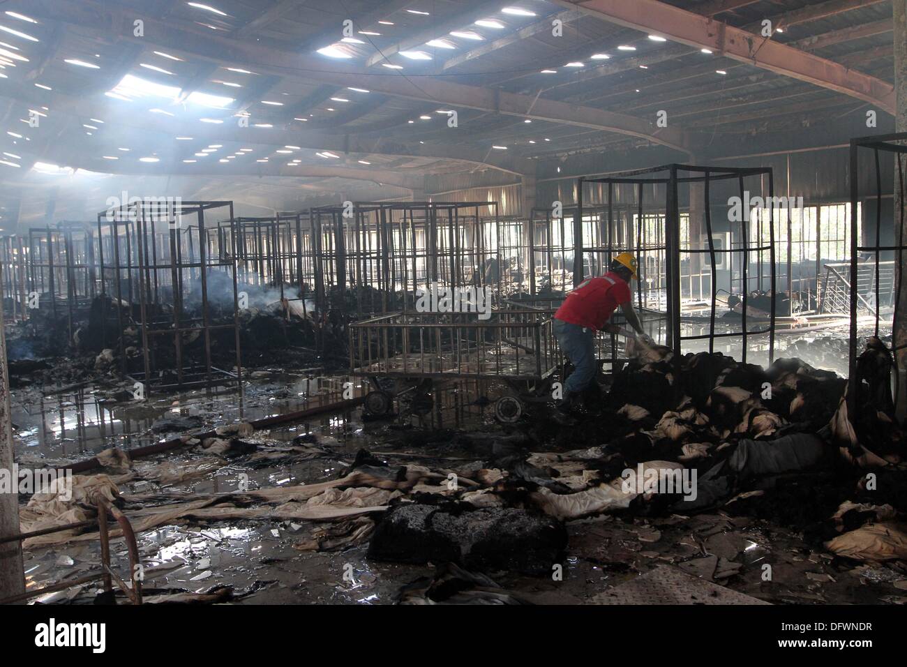 Burned machines are seen in a factory hall after a devastating fire at ...