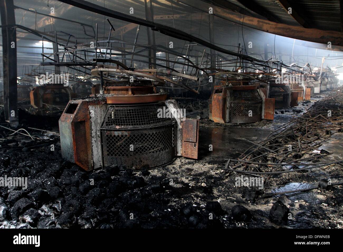 Burned machines are seen in a factory hall after a devastating fire at ...