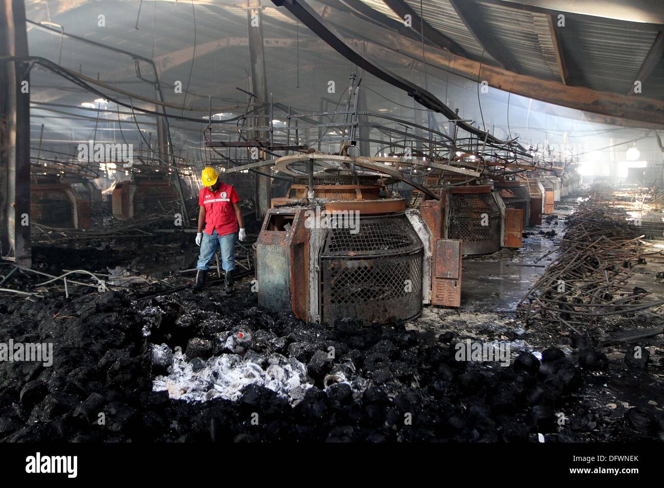 Burned machines are seen in a factory hall after a devastating fire at ...