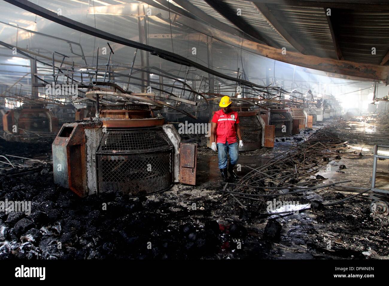 Burned machines are seen in a factory hall after a devastating fire at ...