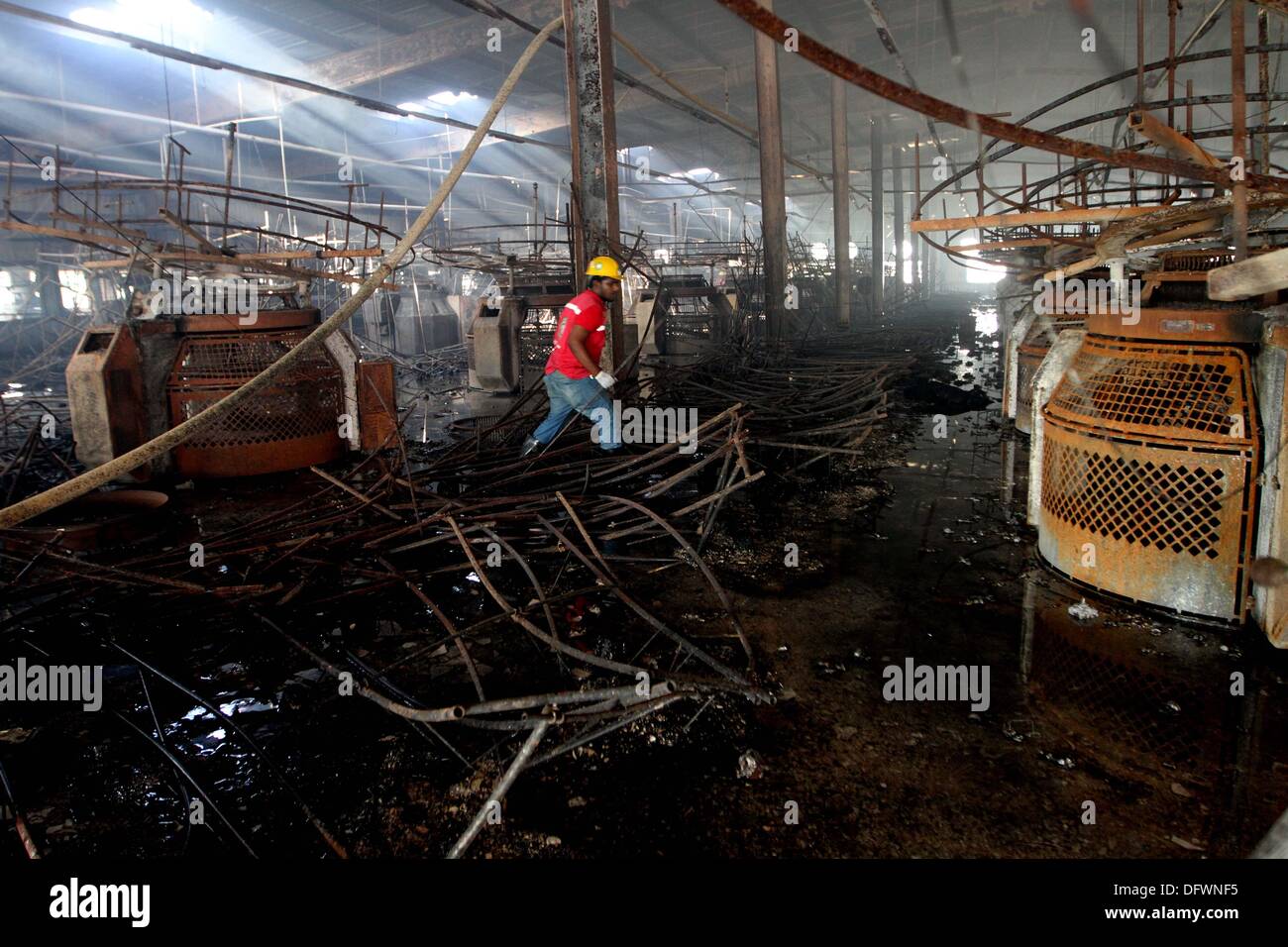 Burned machines are seen in a factory hall after a devastating fire at ...