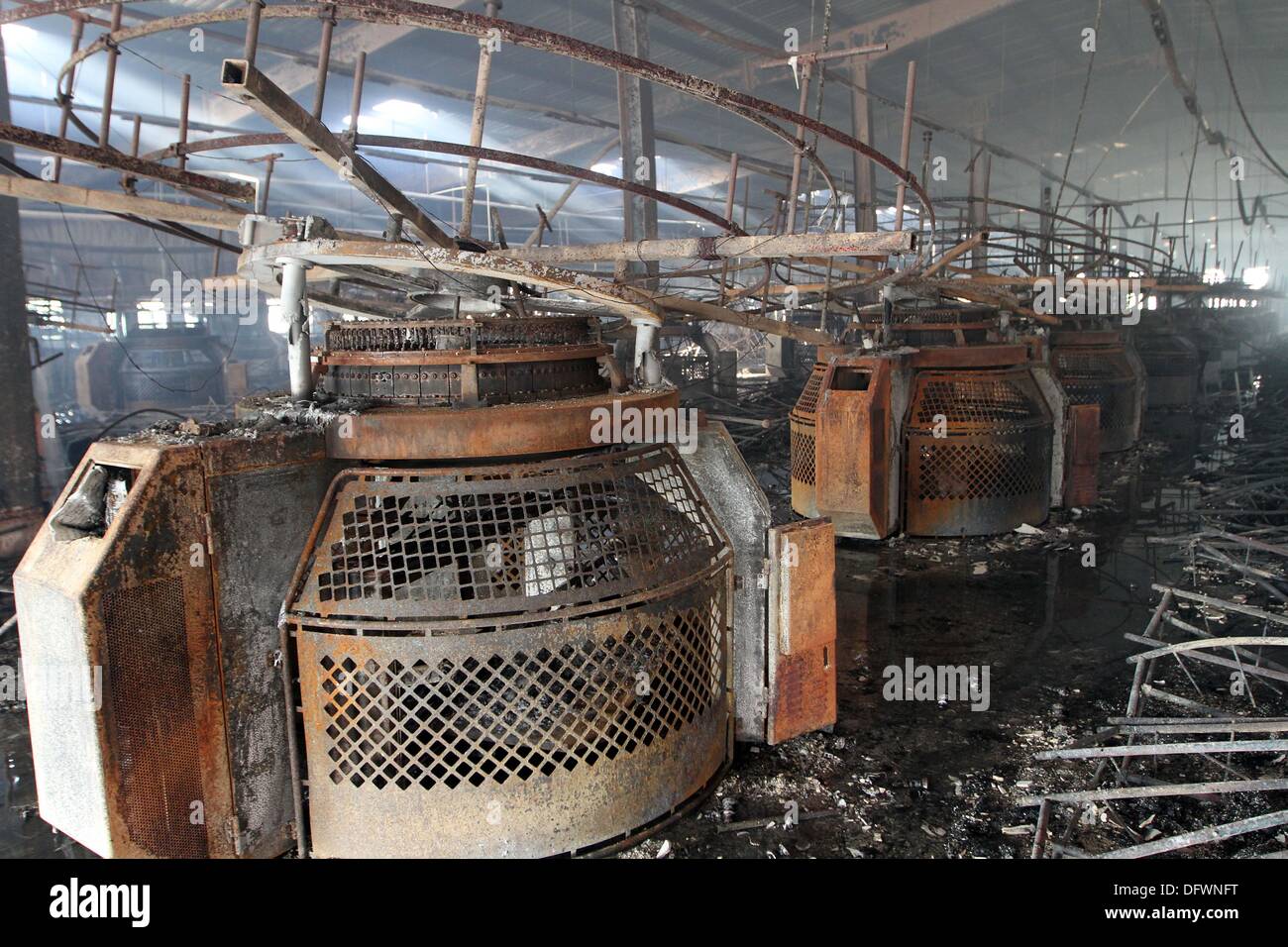 Burned machines are seen in a factory hall after a devastating fire at ...