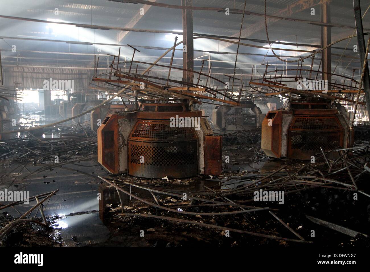 Burned machines are seen in a factory hall after a devastating fire at ...