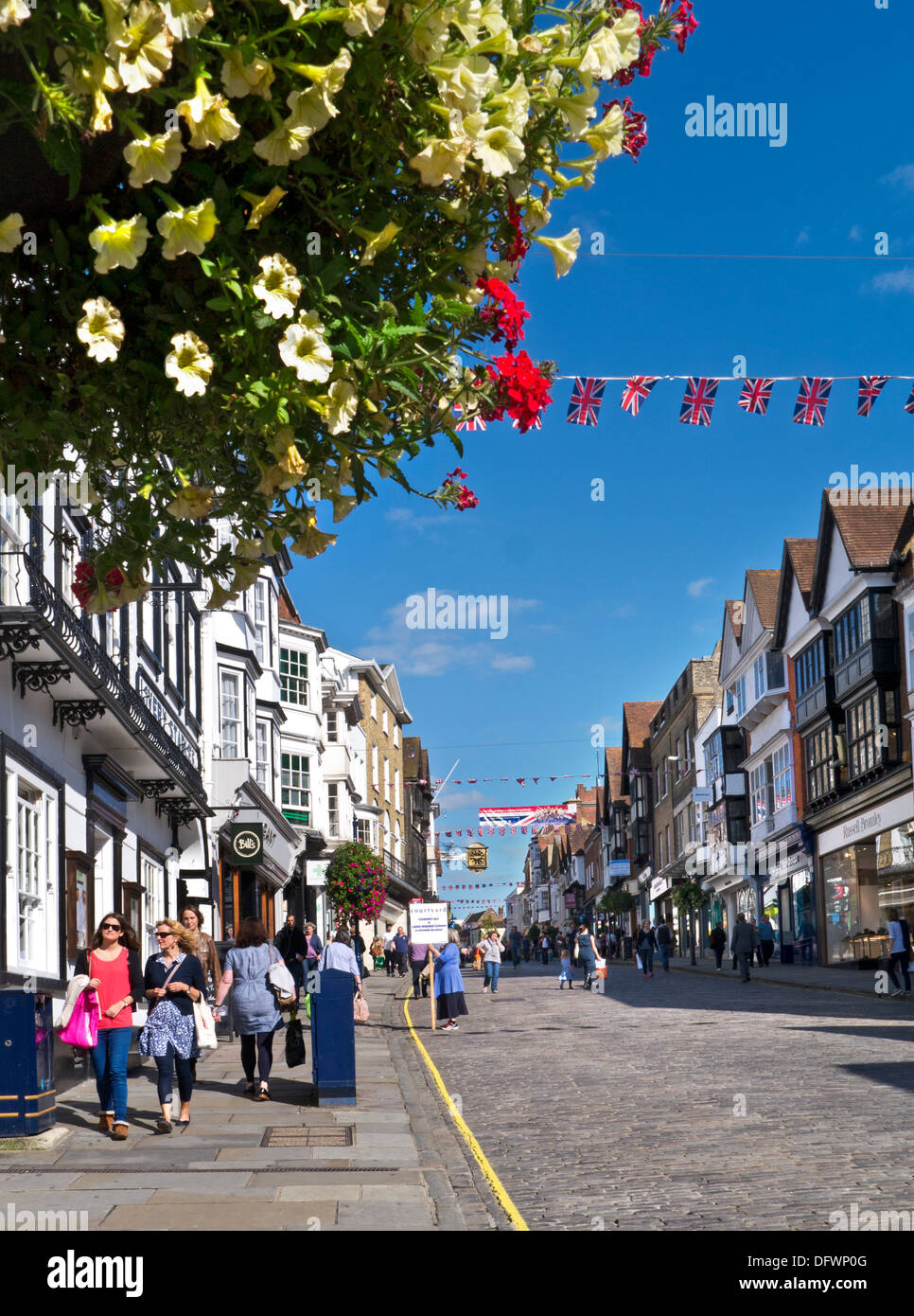 Guildford Shoppers historic High Street with summer flowers and Union ...