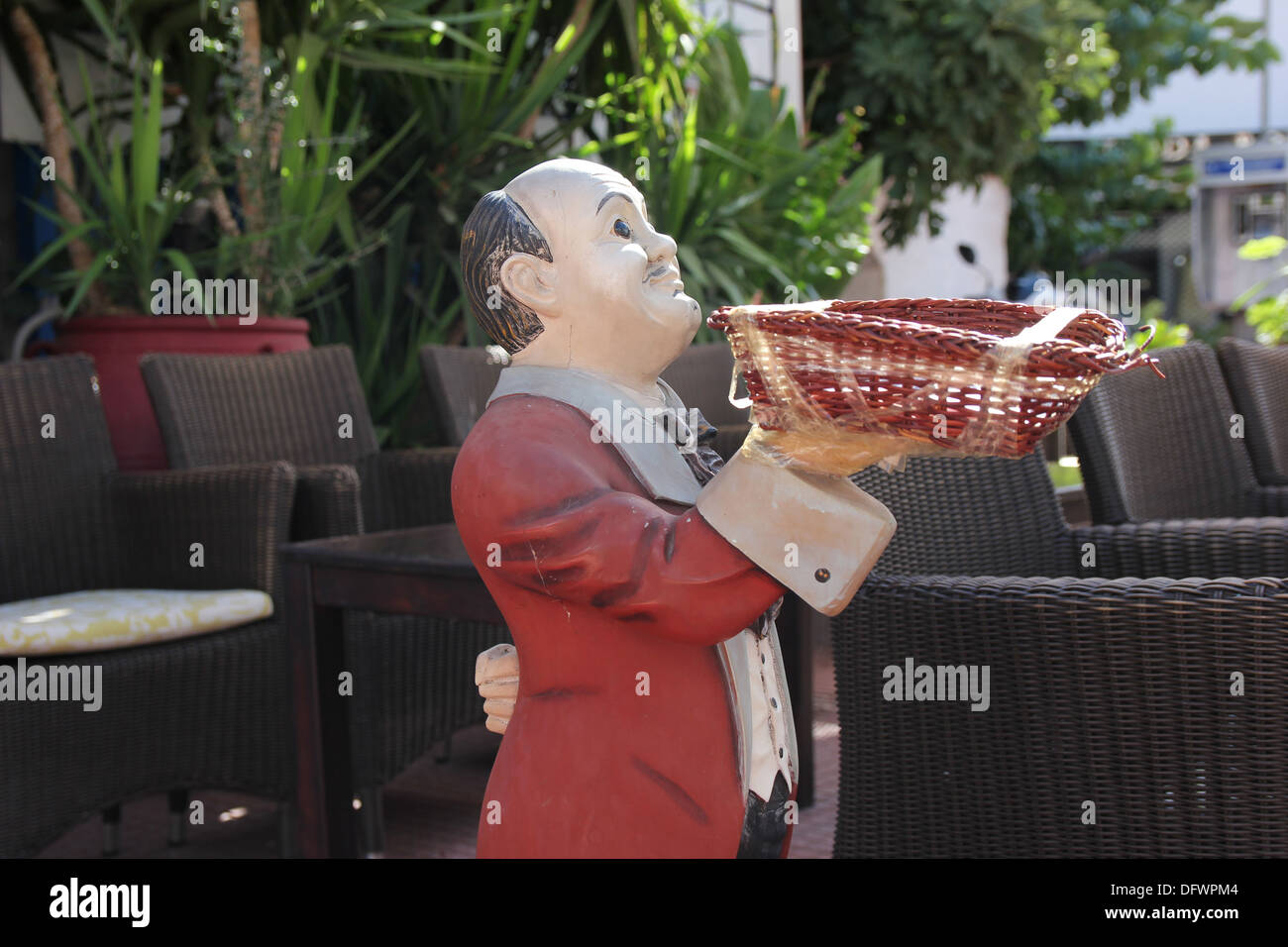 waiter in a red jacket with wicker basket Stock Photo - Alamy