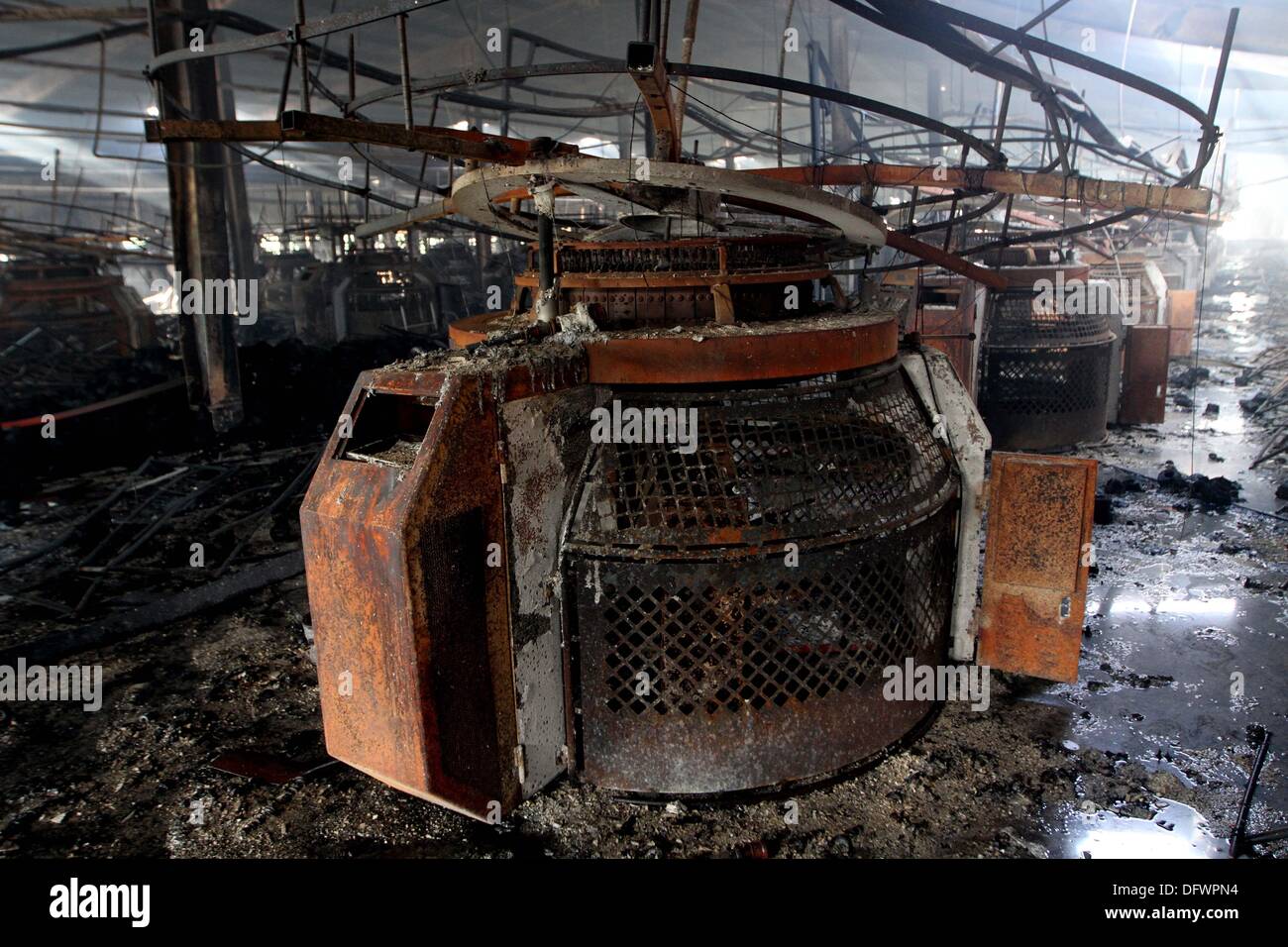 Burned machines are seen in a factory hall after a devastating fire at ...