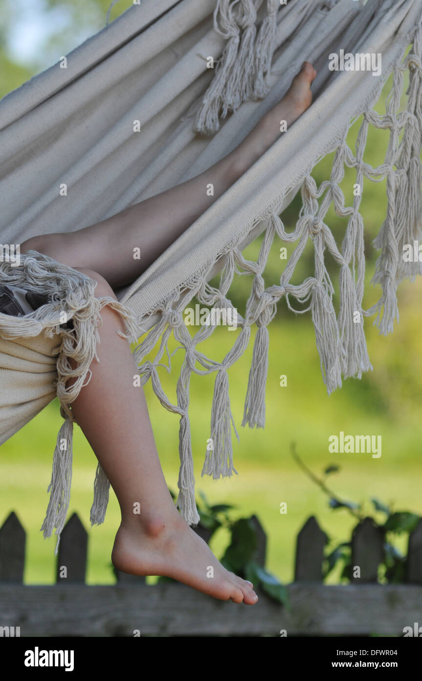 A child's relaxed legs in a hammock Stock Photo - Alamy