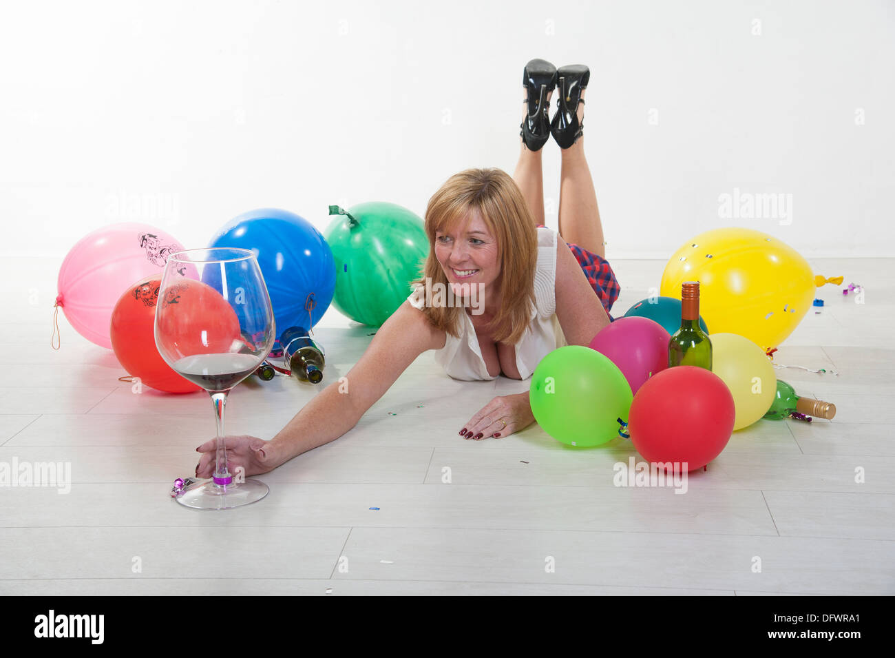 Female party goer reaching for a large glass of wine Stock Photo - Alamy