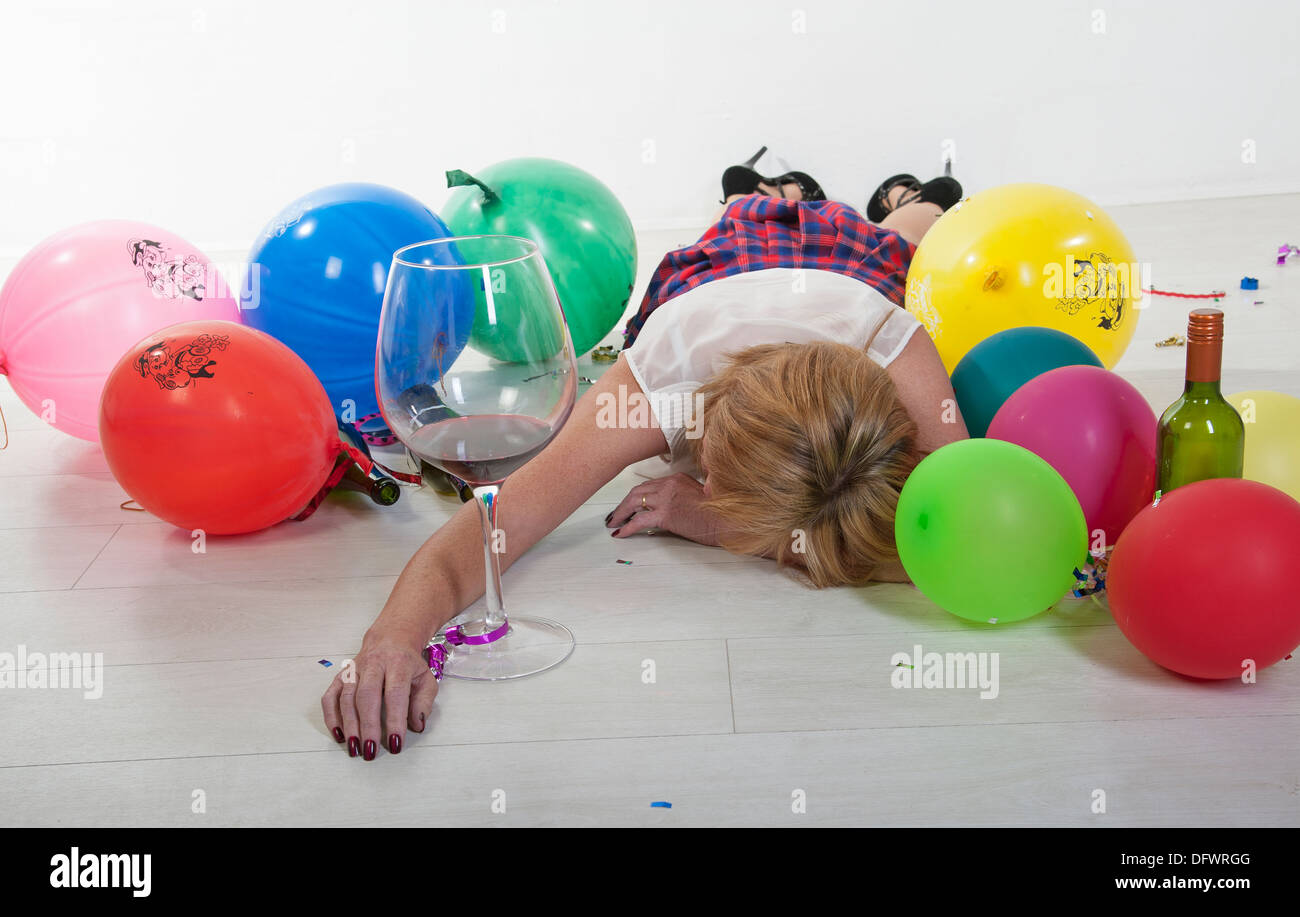 Female office party goer sleeping off the effects of too much alcohol ...