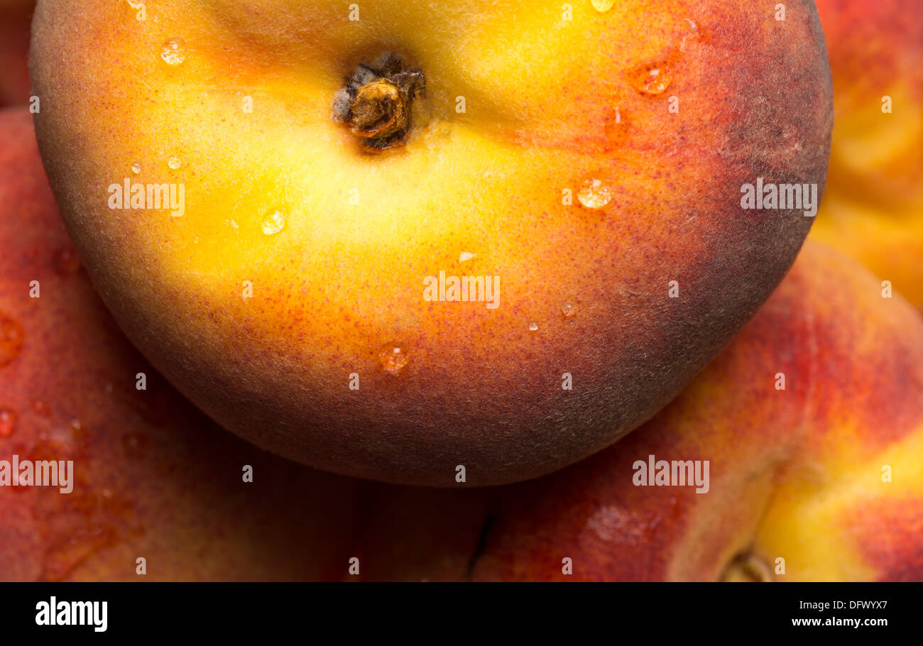 Fuzzy peach top view with water droplets Stock Photo - Alamy