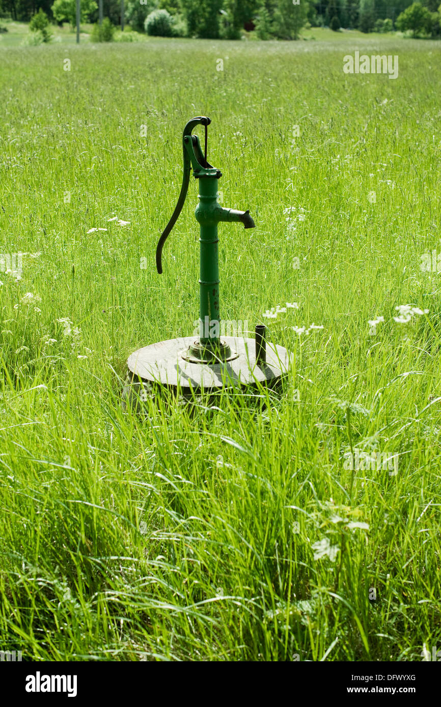 Water Pump in Grassy Field Stock Photo - Alamy