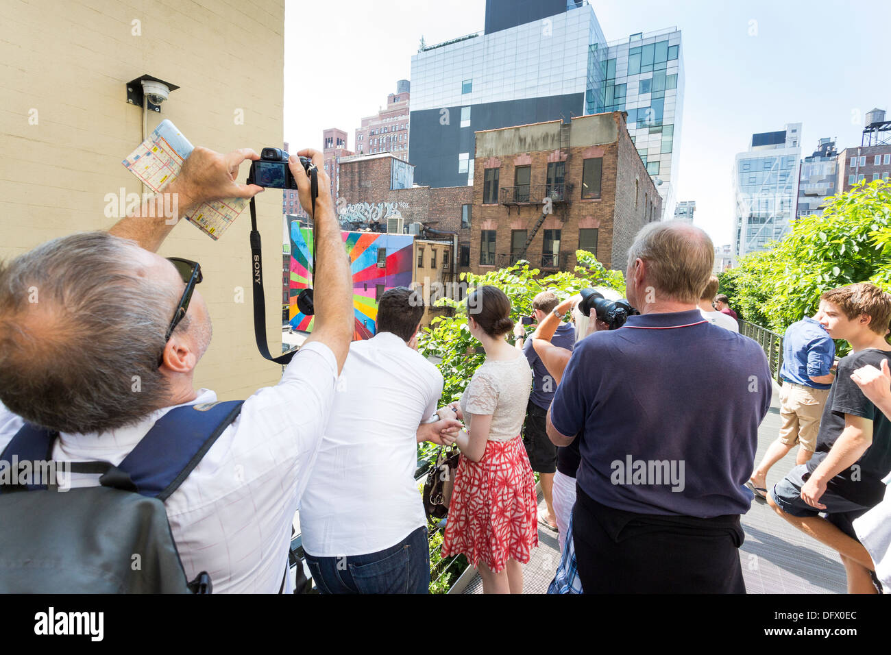 Standing people taking photographs with their cameras Stock Photo - Alamy