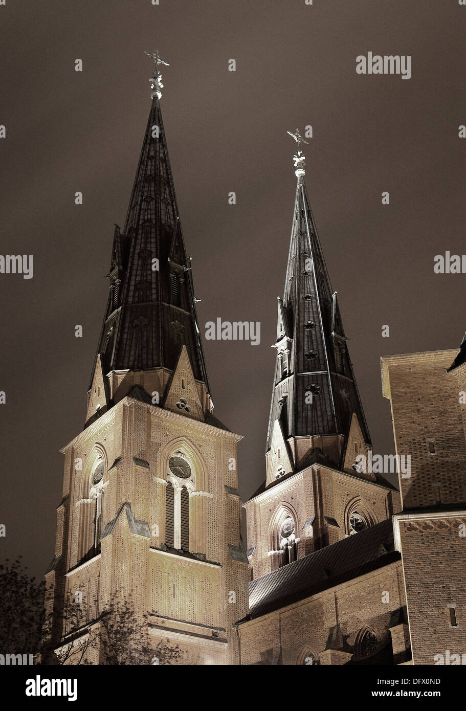 Illuminated Church With Double Spires at Night Stock Photo - Alamy