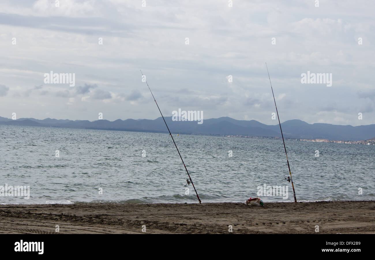 Two fishing rods on the beach Stock Photo - Alamy