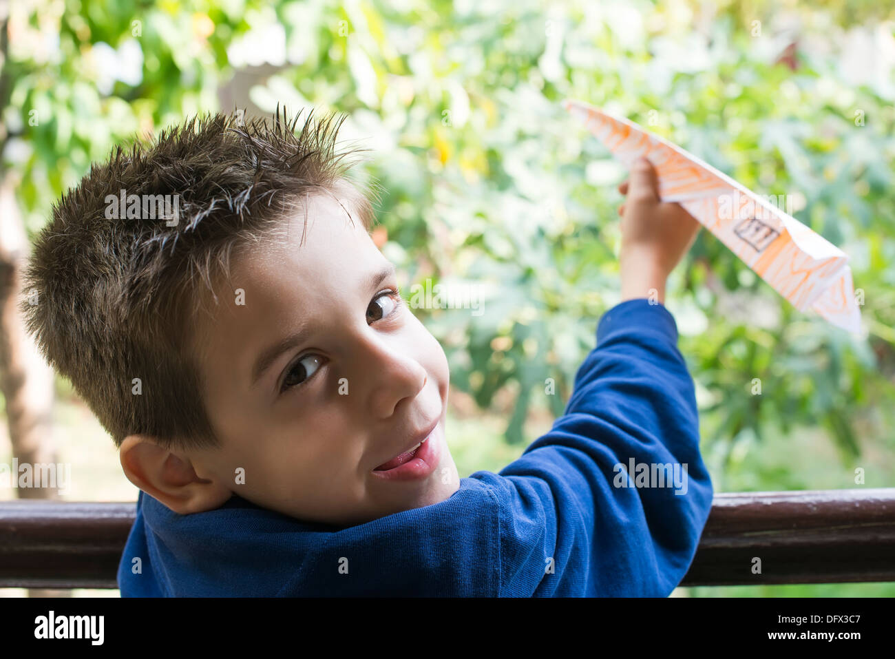 Child throwing paper plane hi-res stock photography and images - Alamy