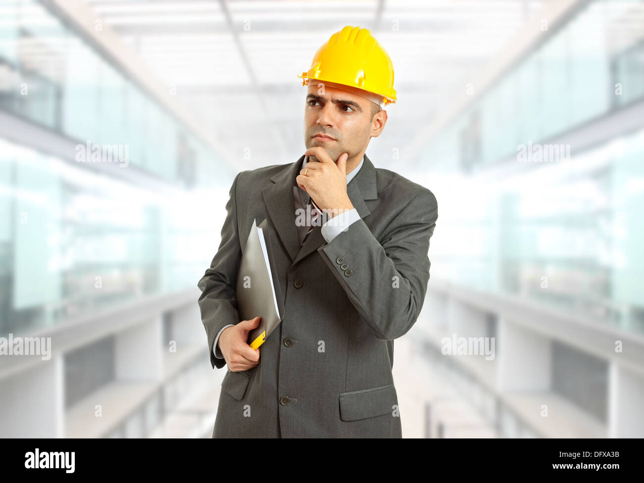 engineer thinking with yellow hat at the office Stock Photo - Alamy