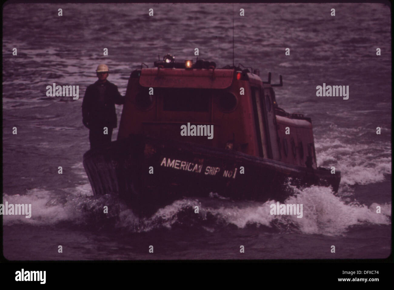 This photograph shows a tugboat and its crew in East Chicago's harbor ...