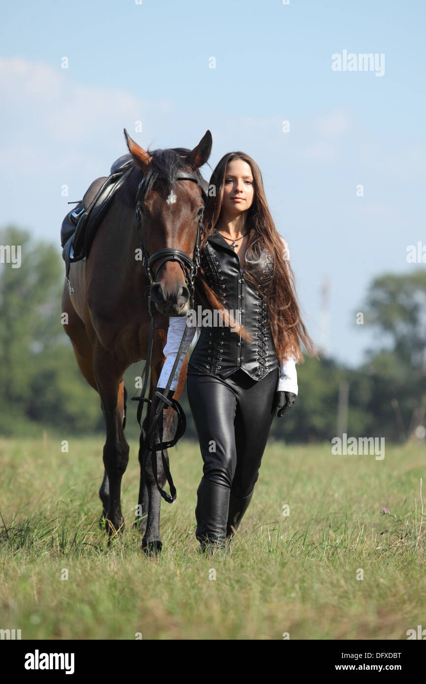 Horse and rider walking together Stock Photo - Alamy