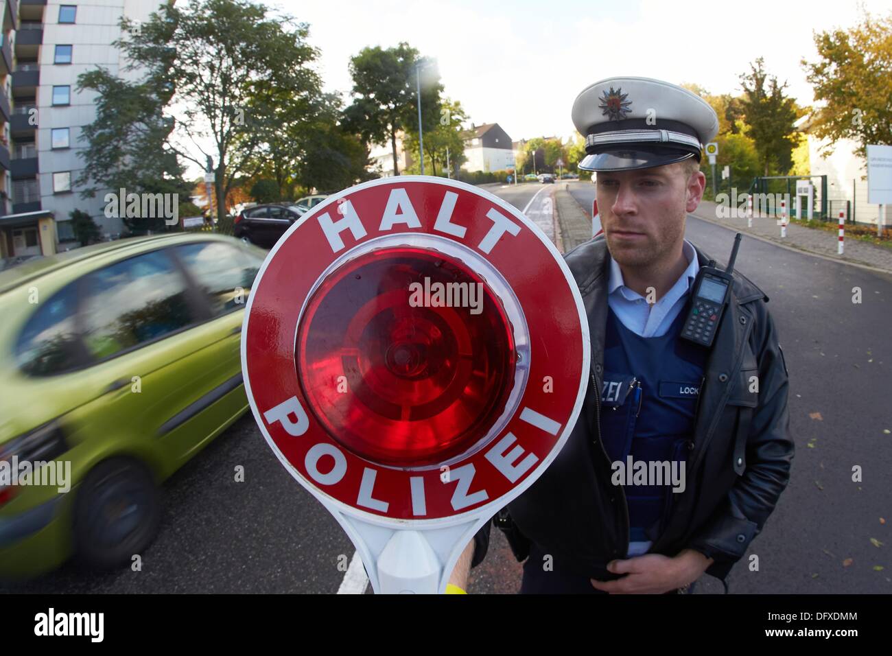 A police office holds up a halt paddle in Andernach, Germany, 10 ...