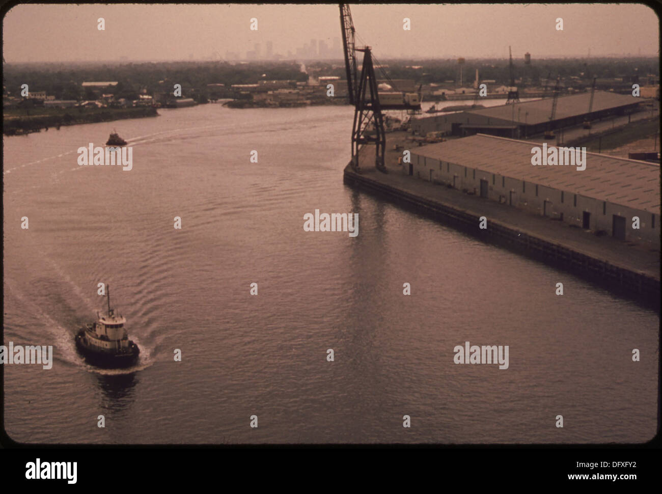 This image shows tugboats navigating the industrial Houston Ship ...