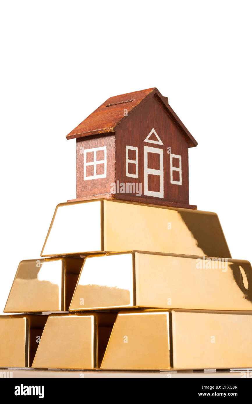 Gold bricks and model house Stock Photo - Alamy