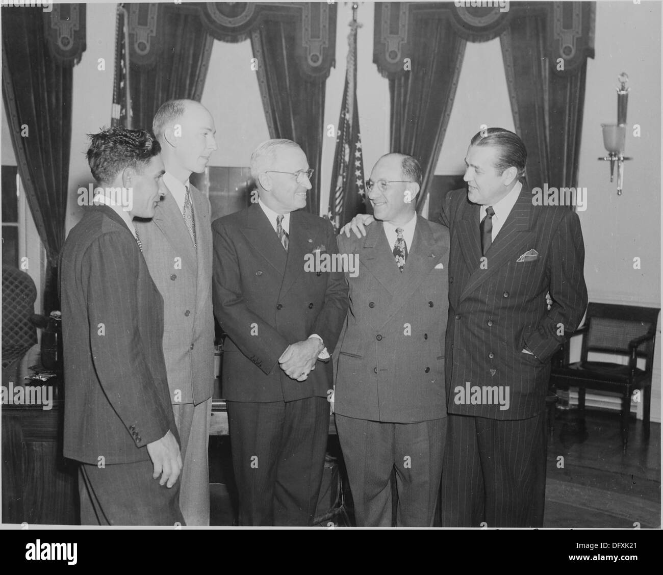 President Harry S. Truman greets the crew members of an around-the ...