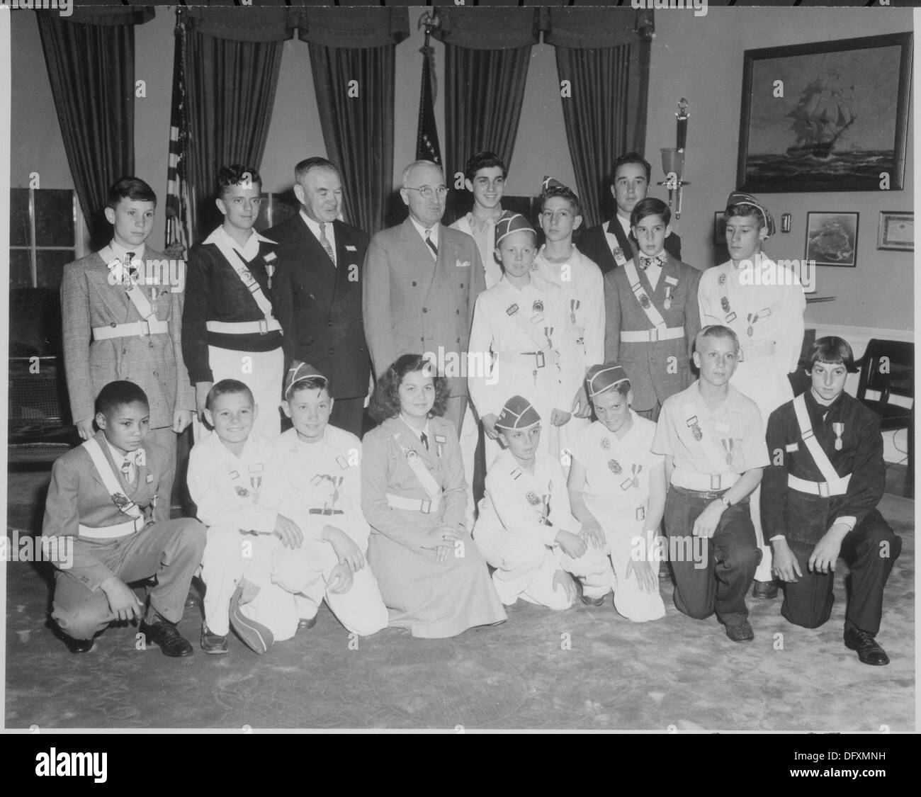 This photograph shows President Harry S. Truman in the Oval Office with ...