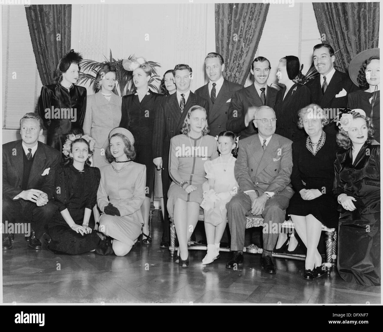 This photograph shows movie stars posing with President Harry S. Truman ...