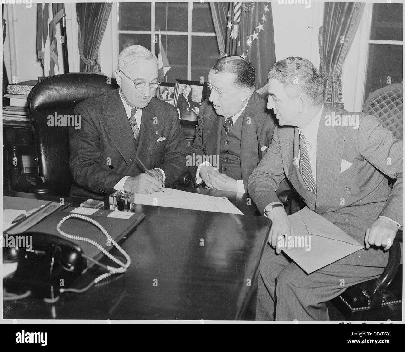 A photograph of President Harry S. Truman signing the Red Cross ...