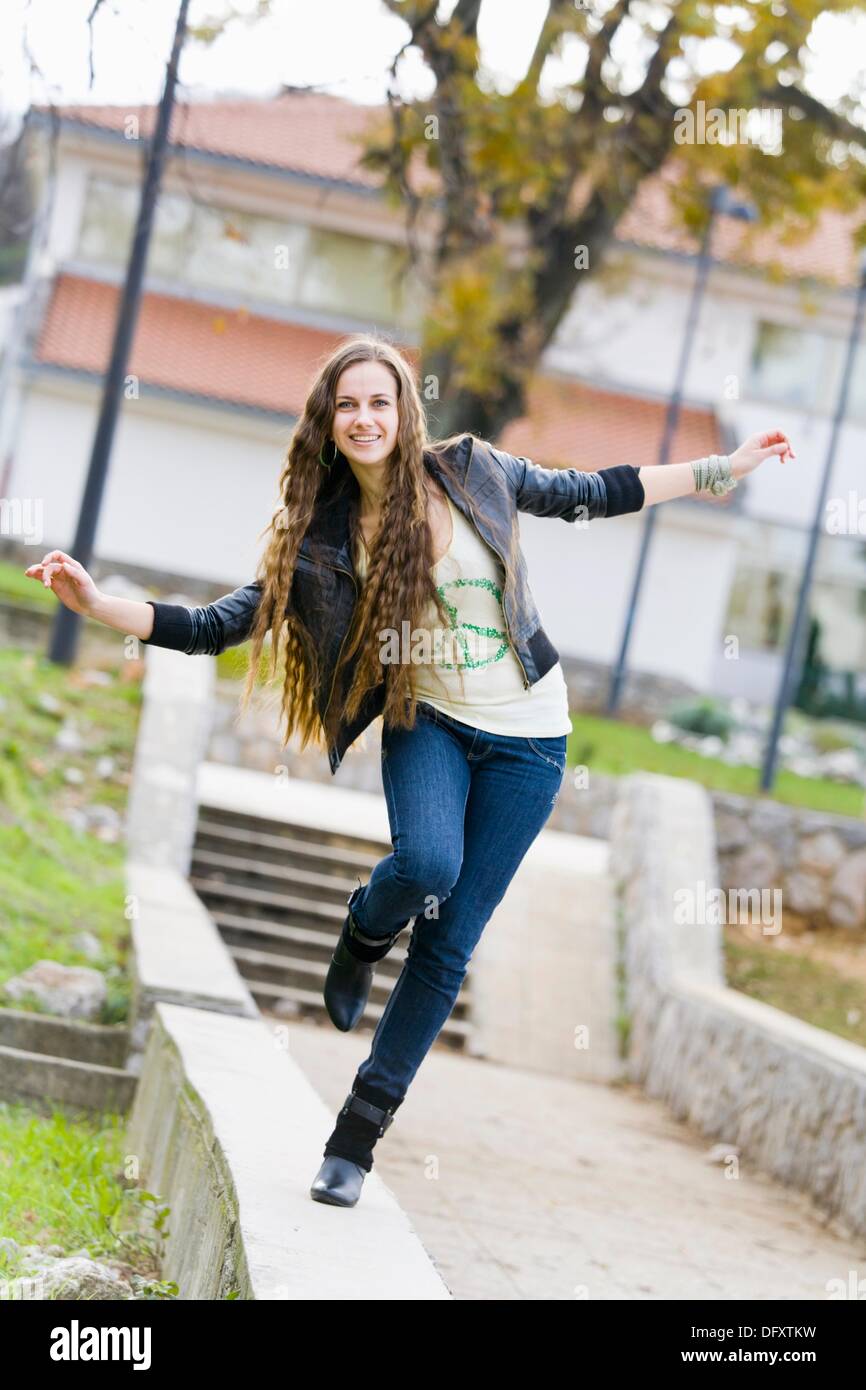 Balancing on one leg in the park young woman Stock Photo - Alamy