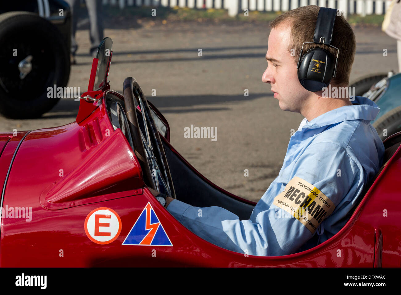 Mechanic brings the 1934 Alfa Romeo Tipo B into the holding paddock ...