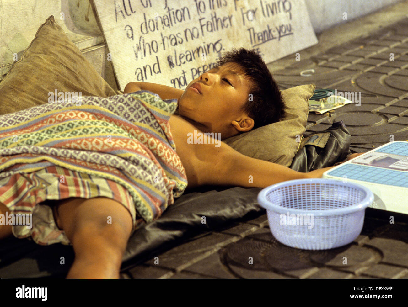 Child is begging on the streets at night and sleeps Stock Photo - Alamy