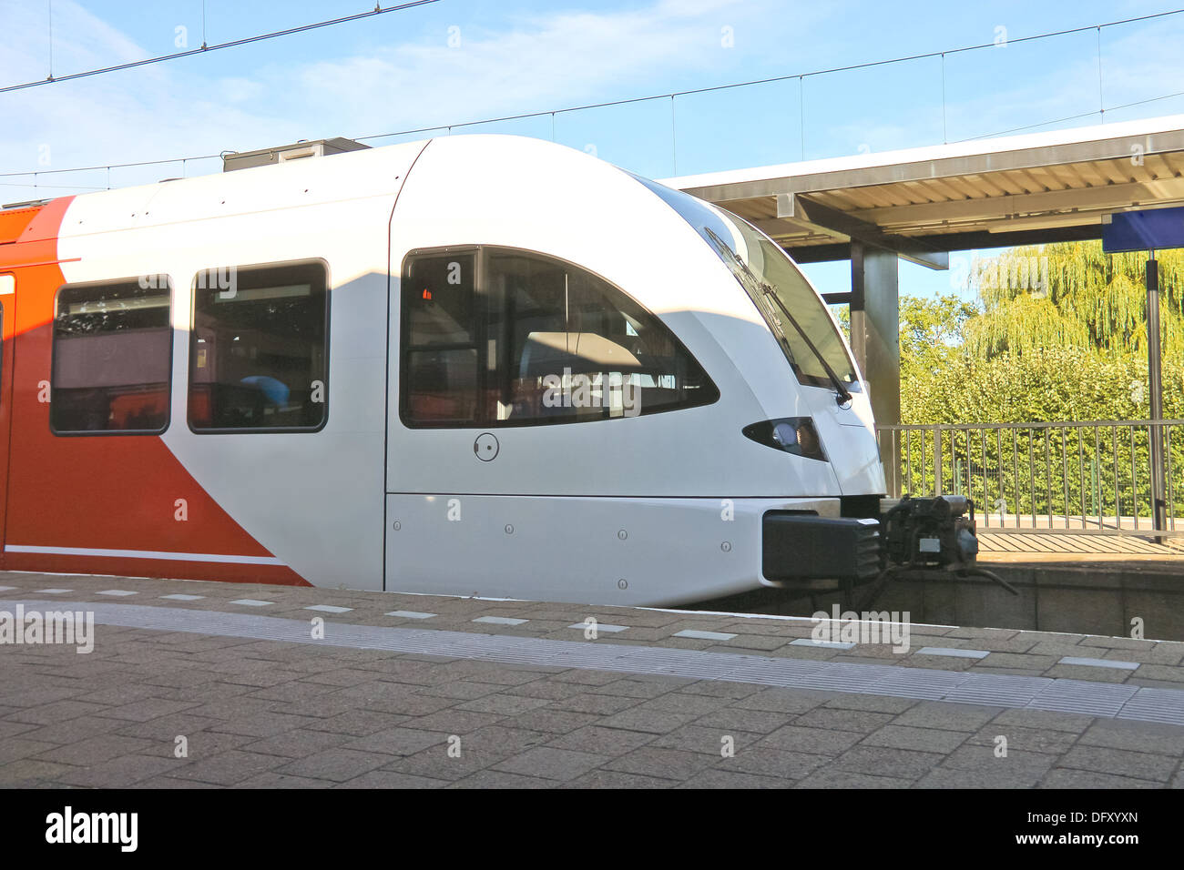 Arrival of the train at railway station Stock Photo - Alamy