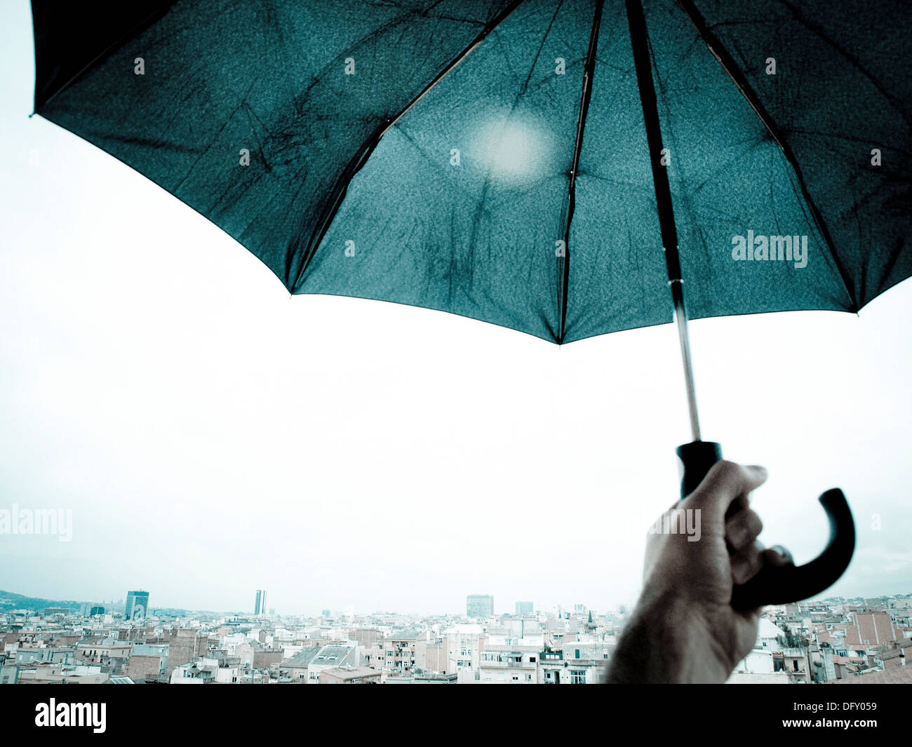 Hand holding an umbrella Stock Photo - Alamy