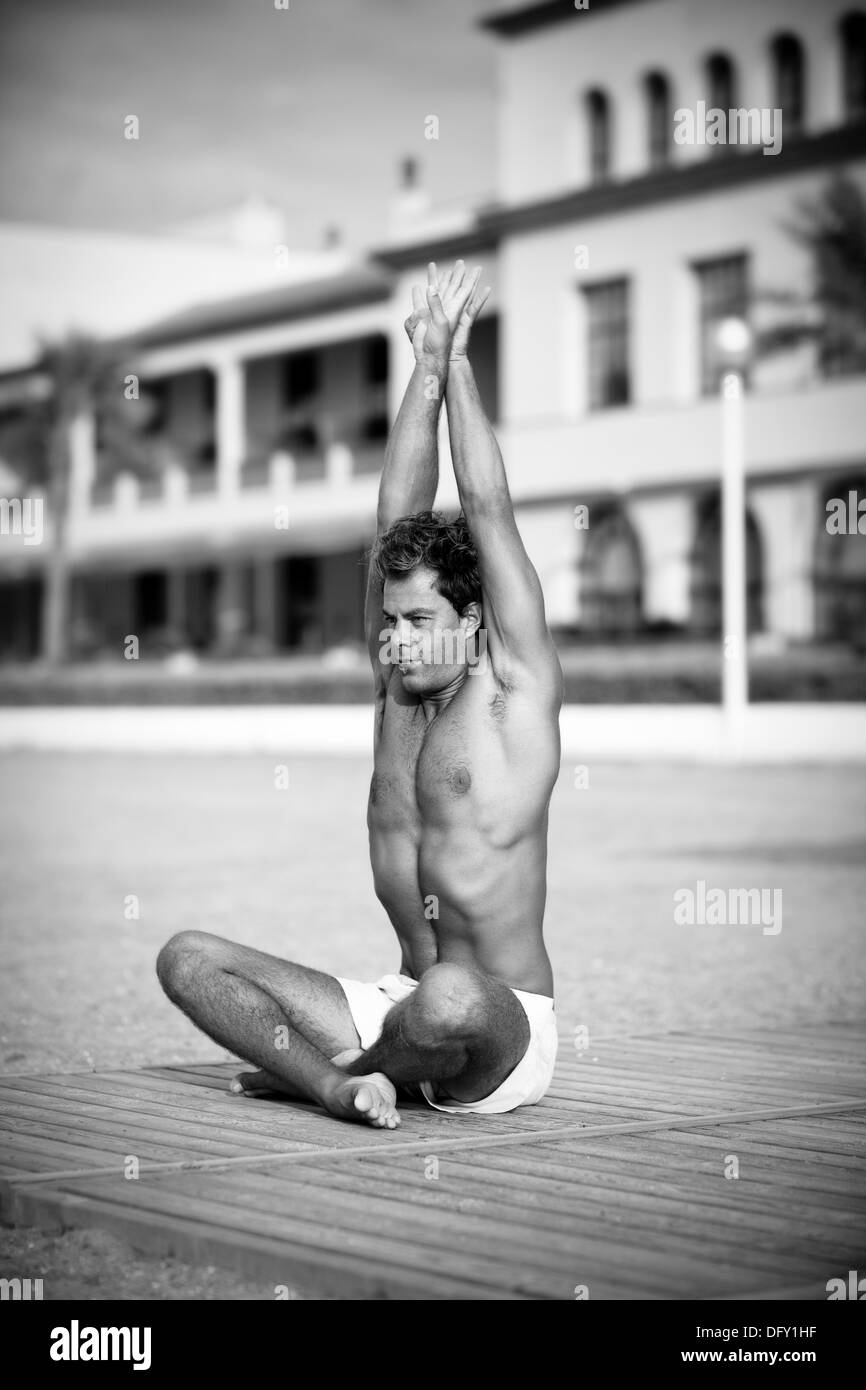 Young man doing gymnastics on the beach Stock Photo - Alamy