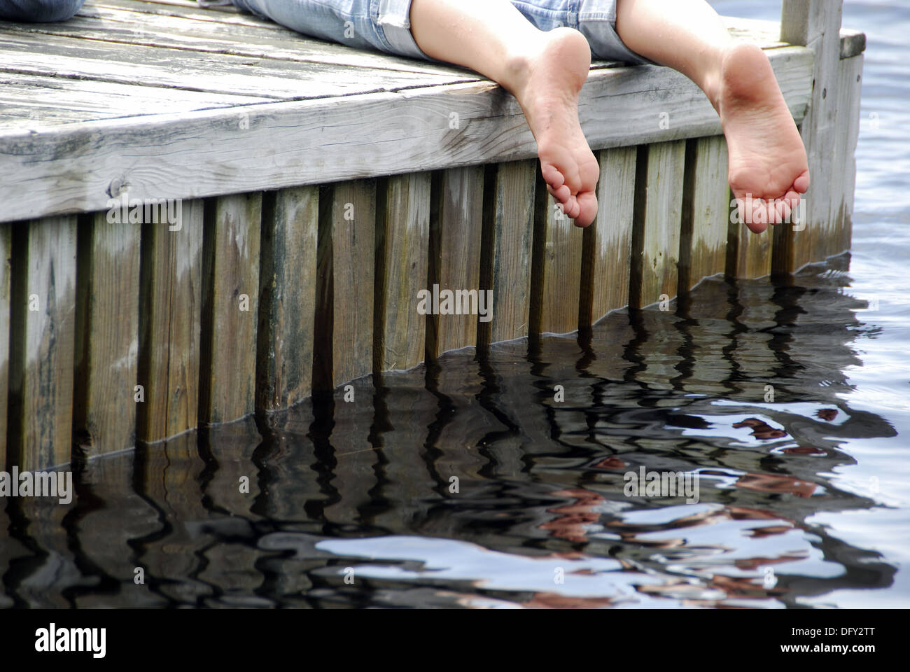 Feet hang off dock hi-res stock photography and images - Alamy
