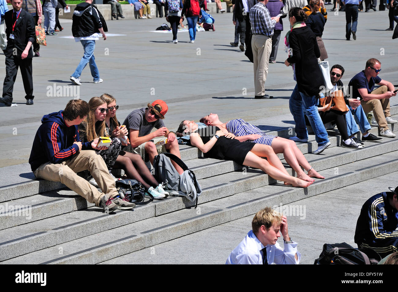 London, England, UK. Trafalgar Square - people sitting on the steps in ...