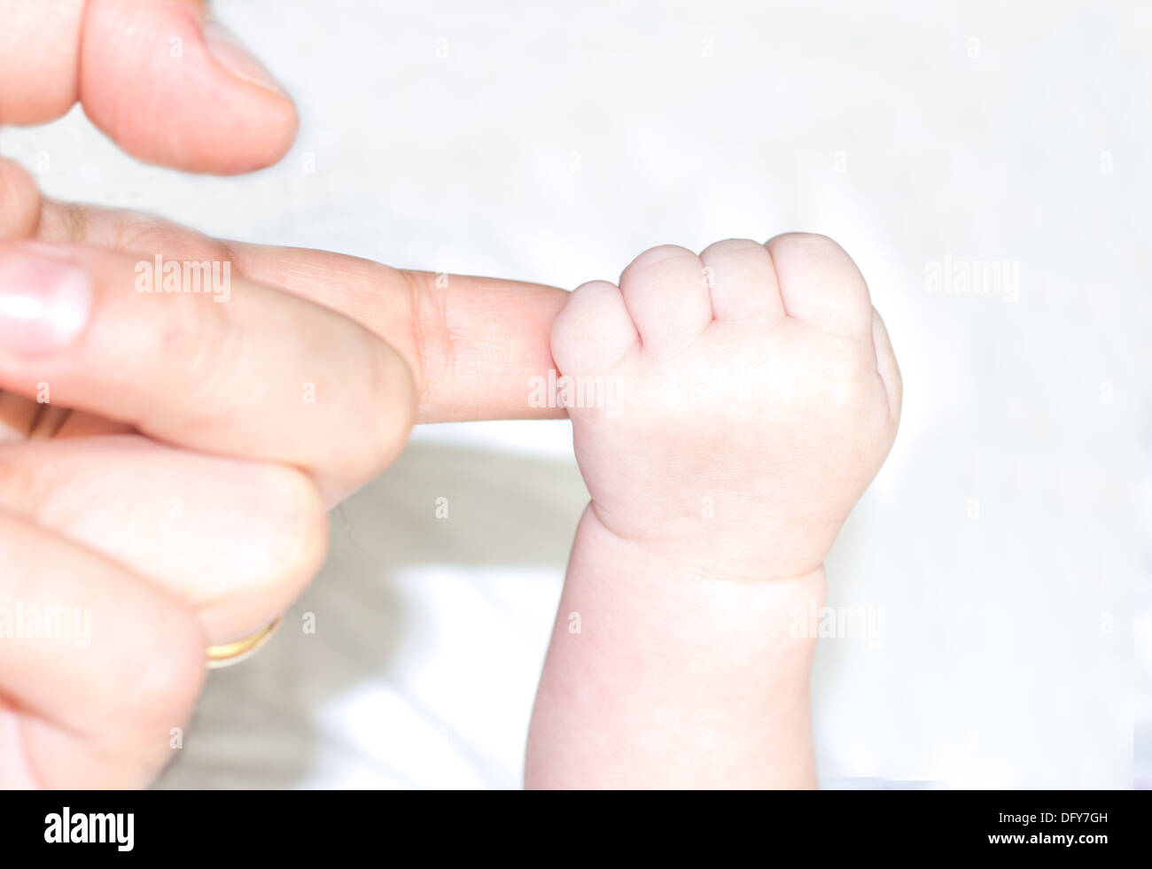 Baby catching mother's finger Stock Photo - Alamy