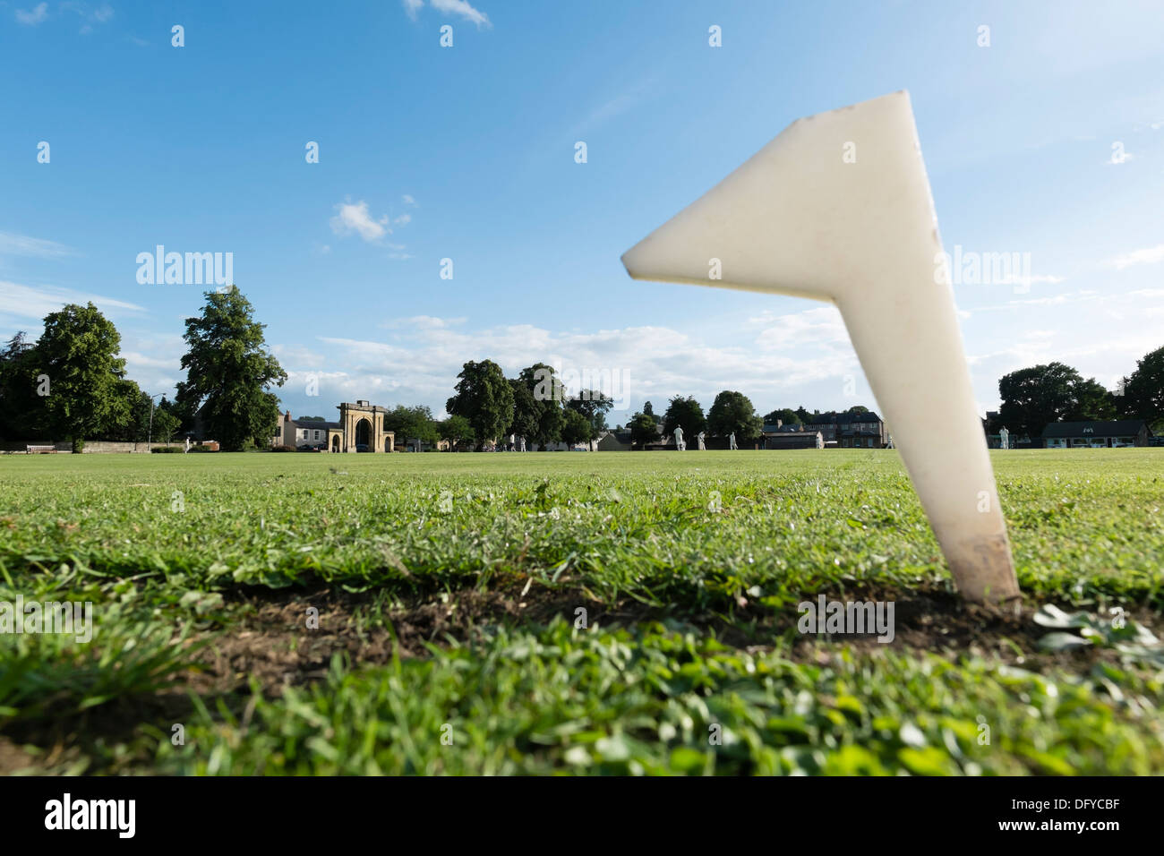 Cricket pitch boundary marker with game played beyond in distance Stock ...