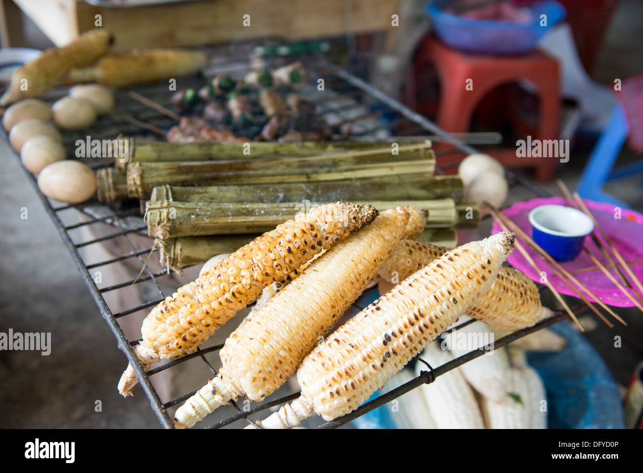 Vietnamese people sell the grill corn near the tourist sight , Sa Pa ...