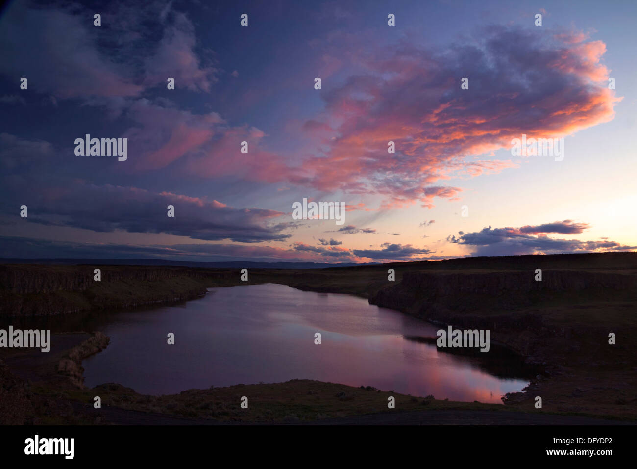 WASHINGTON - Sunset over Heart Lake and the prairie lands and buttes of ...